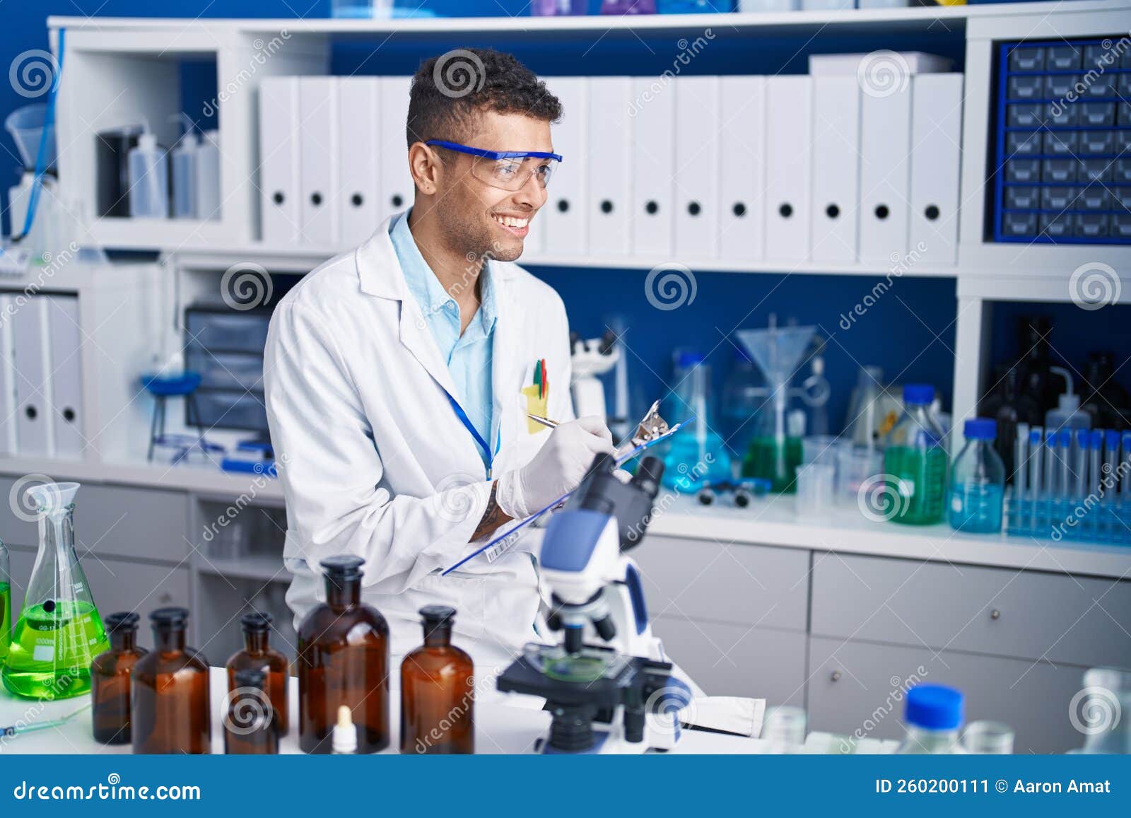 African American Man Scientist Writing on Document at Laboratory Stock ...
