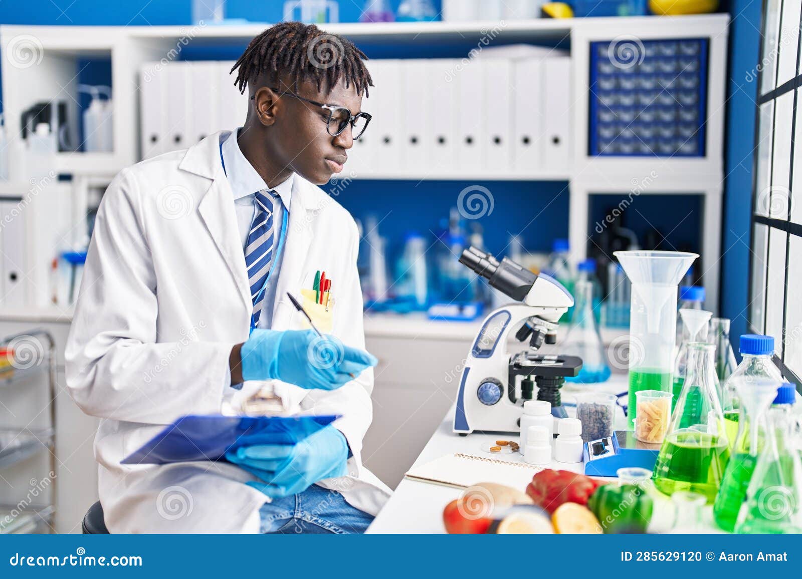 African American Man Scientist Writing Report at Laboratory Stock Photo ...
