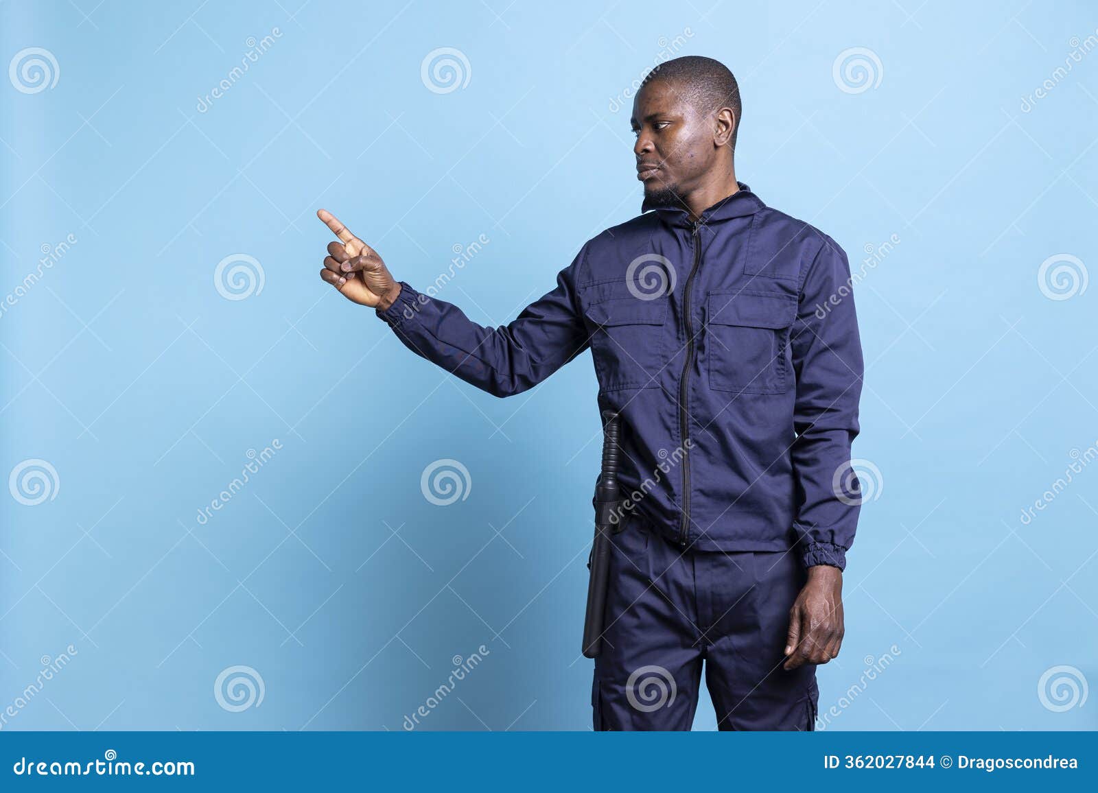 African American Man in Security Guard Uniform Pointing To the Left ...
