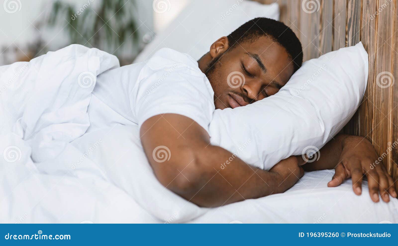 African Man Sleeping Hugging Pillow Lying in Bed at Home Stock Photo ... African Man Sleeping Hugging Pillow Lying in Bed at Home Stock Photo ...