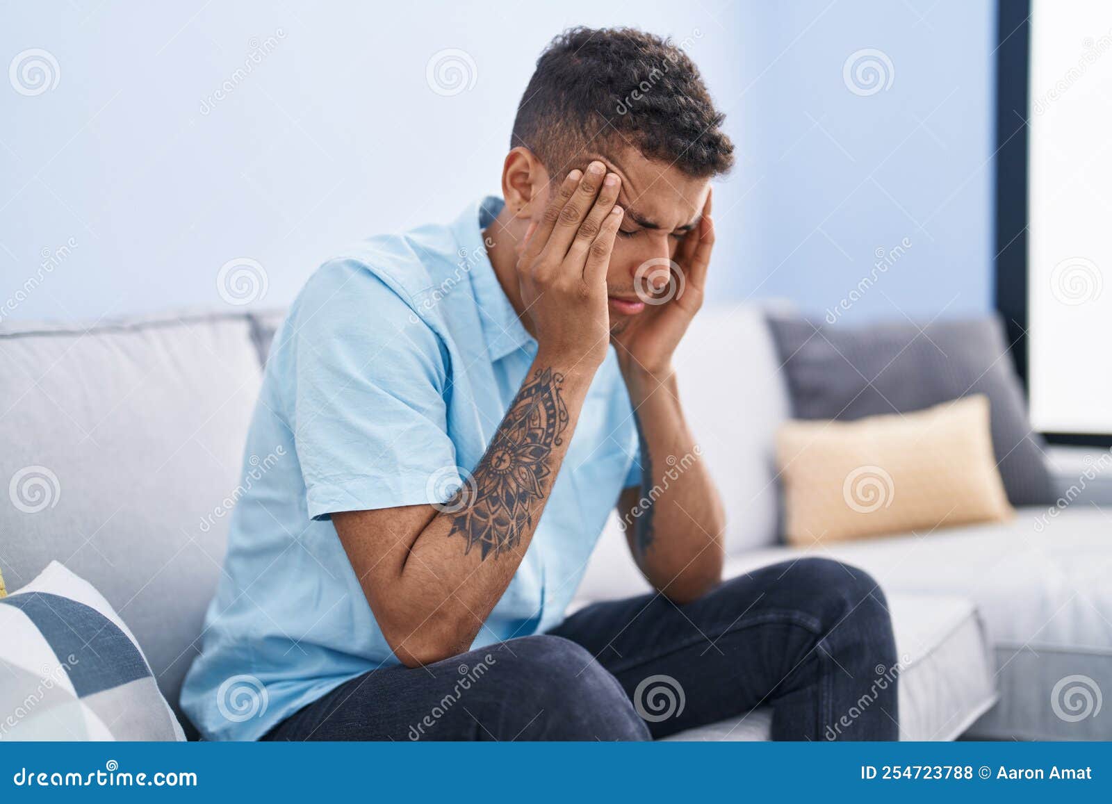 African American Man Stressed Sitting on Sofa at Home Stock Photo ...