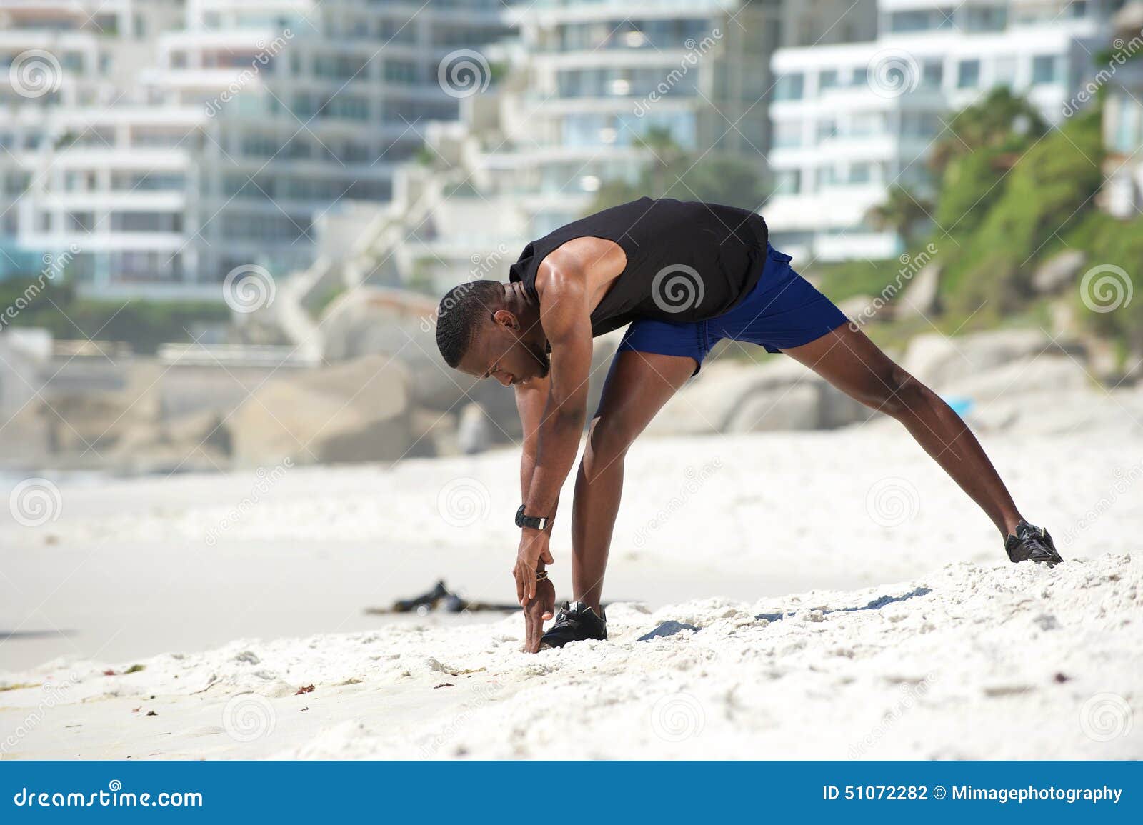 African American Man Stretching Muscles Exercise at the Beach Stock ...