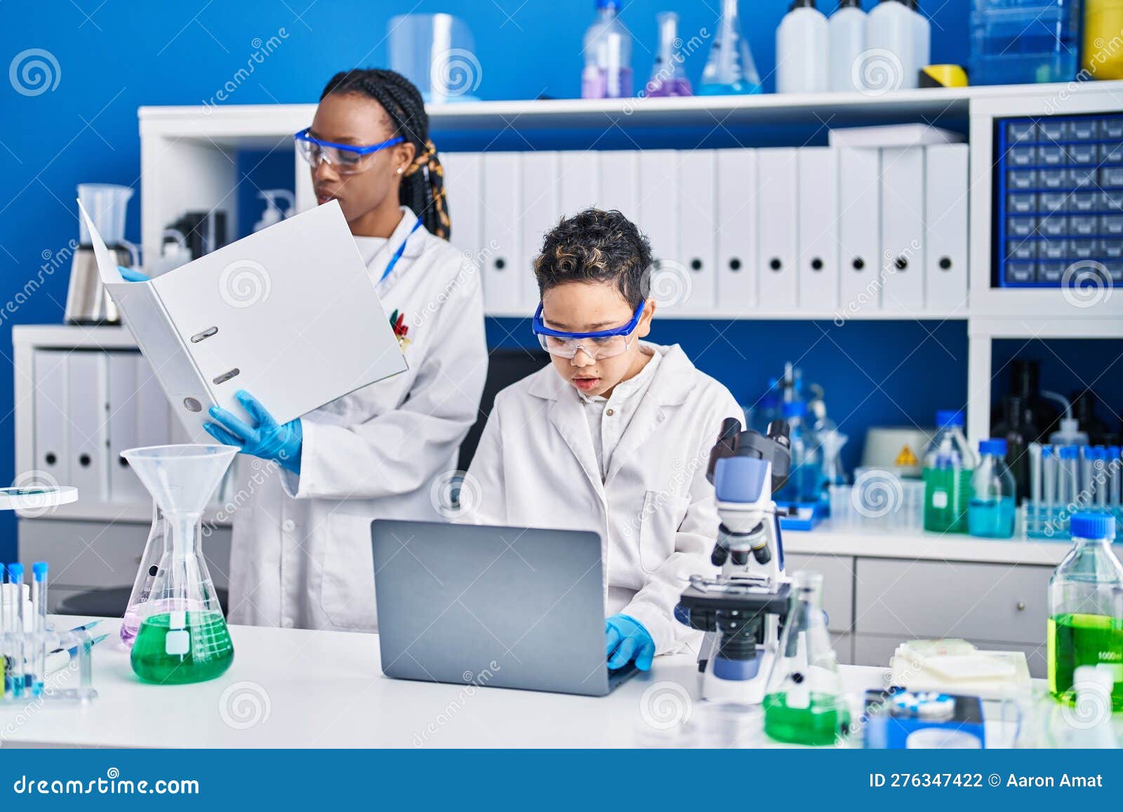 African American Mother and Son Scientists Using Laptop Working ...