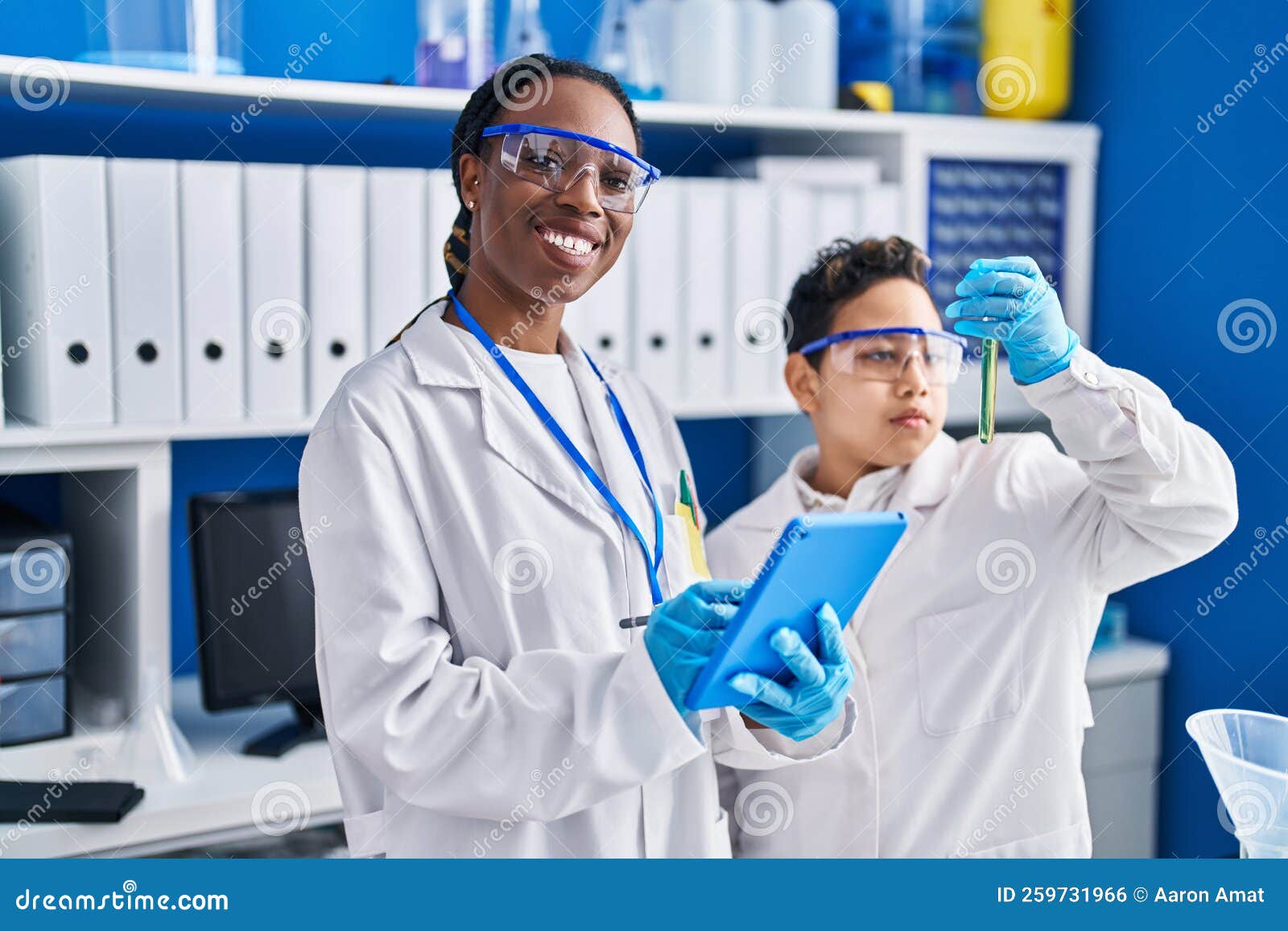 African American Mother and Son Scientists Using Touchpad Working ...