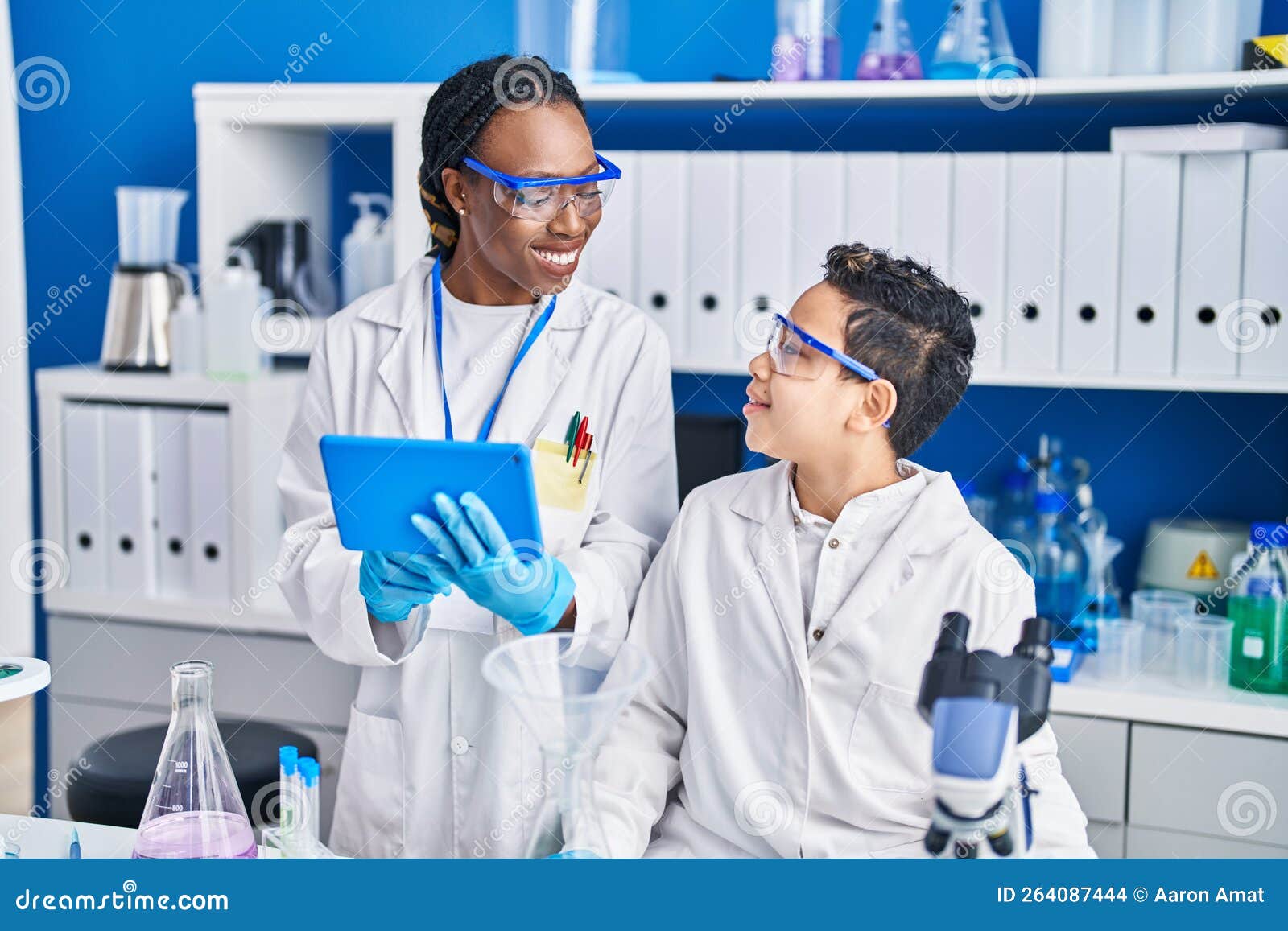 African American Mother and Son Scientists Using Touchpad Working ...