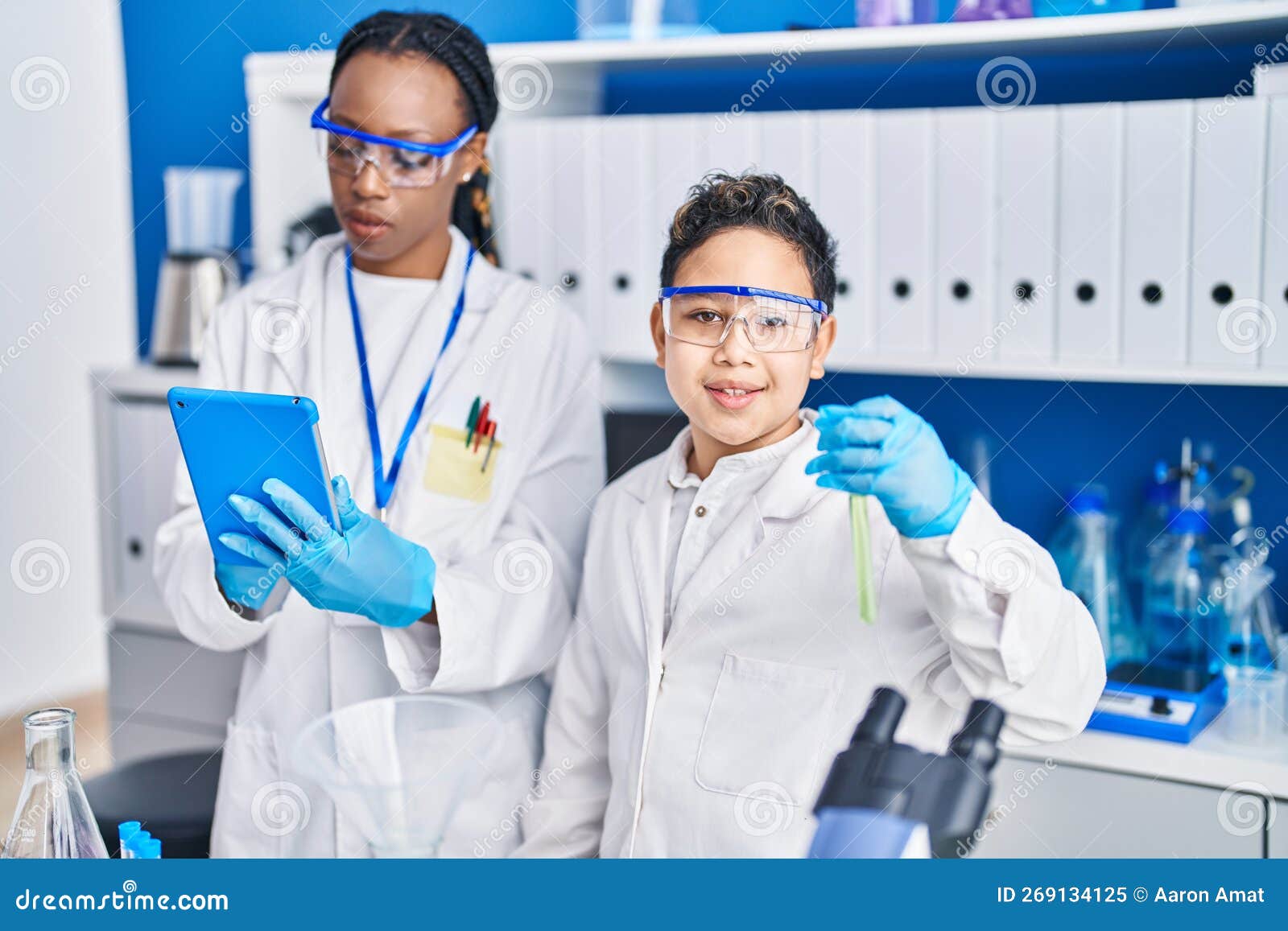African American Mother and Son Scientists Using Touchpad Working ...