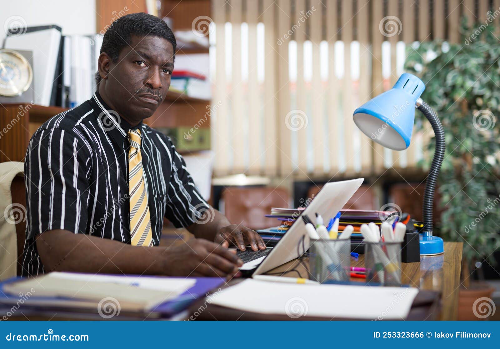 African American Office Manager Working on Computer at Desk Stock Photo ...