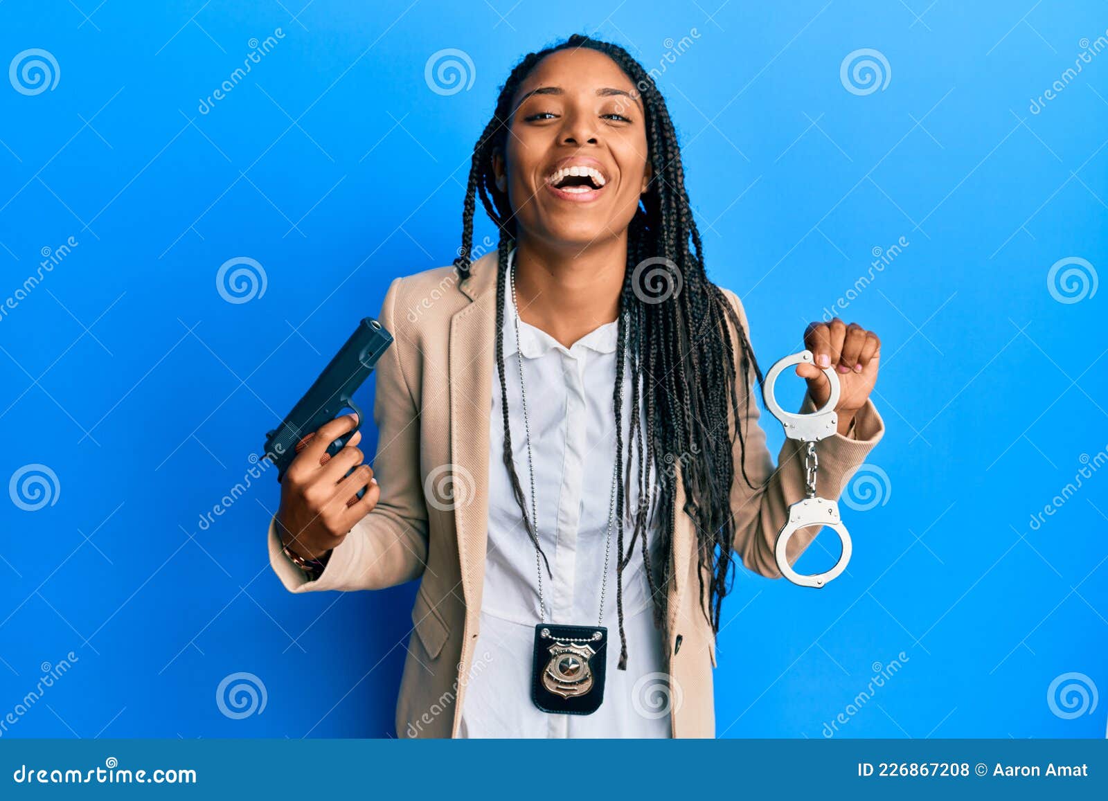 African American Police Woman Holding Gun And Handcuffs Smiling And