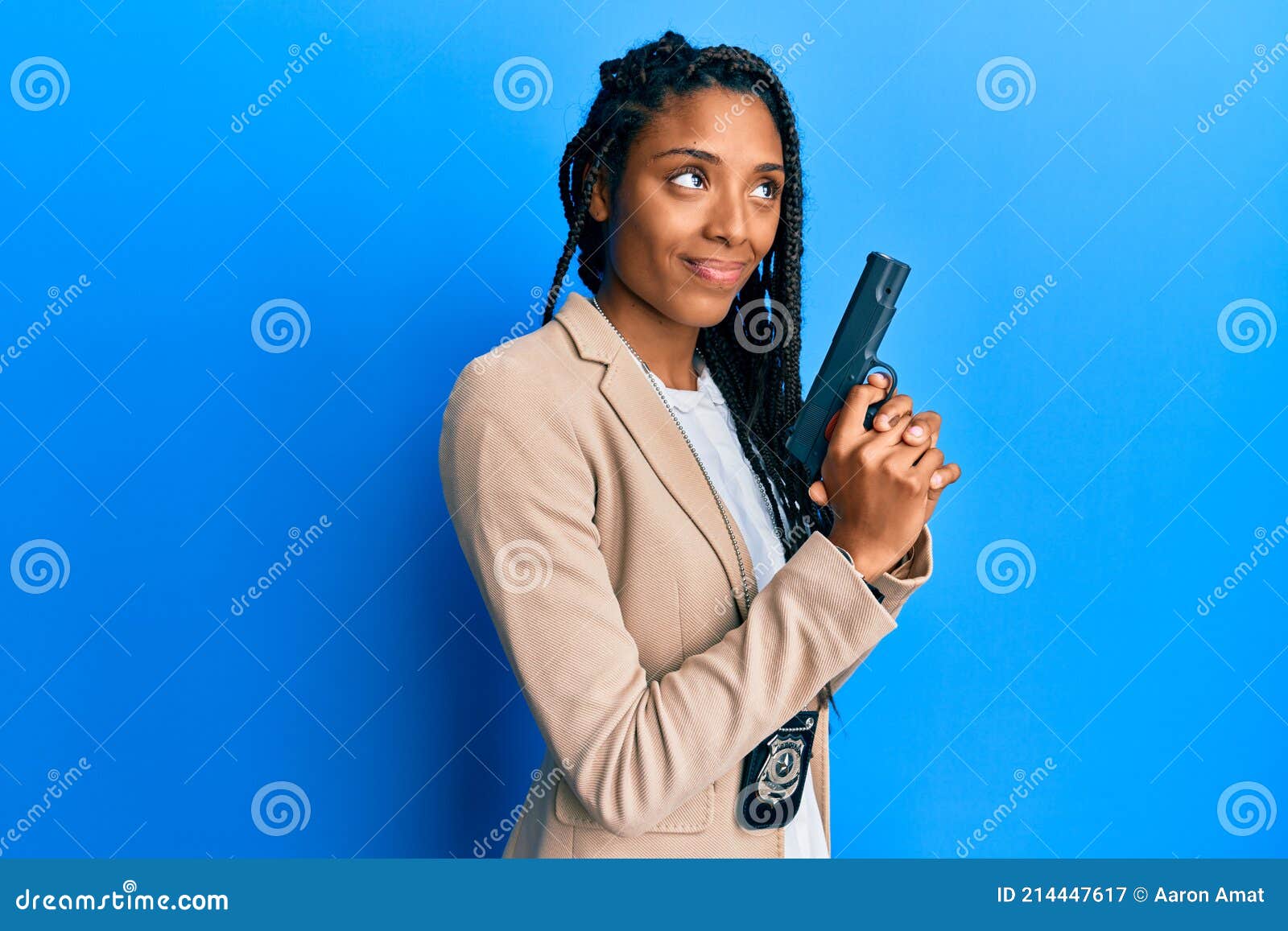African American Police Woman Holding Gun Smiling Looking To The Side