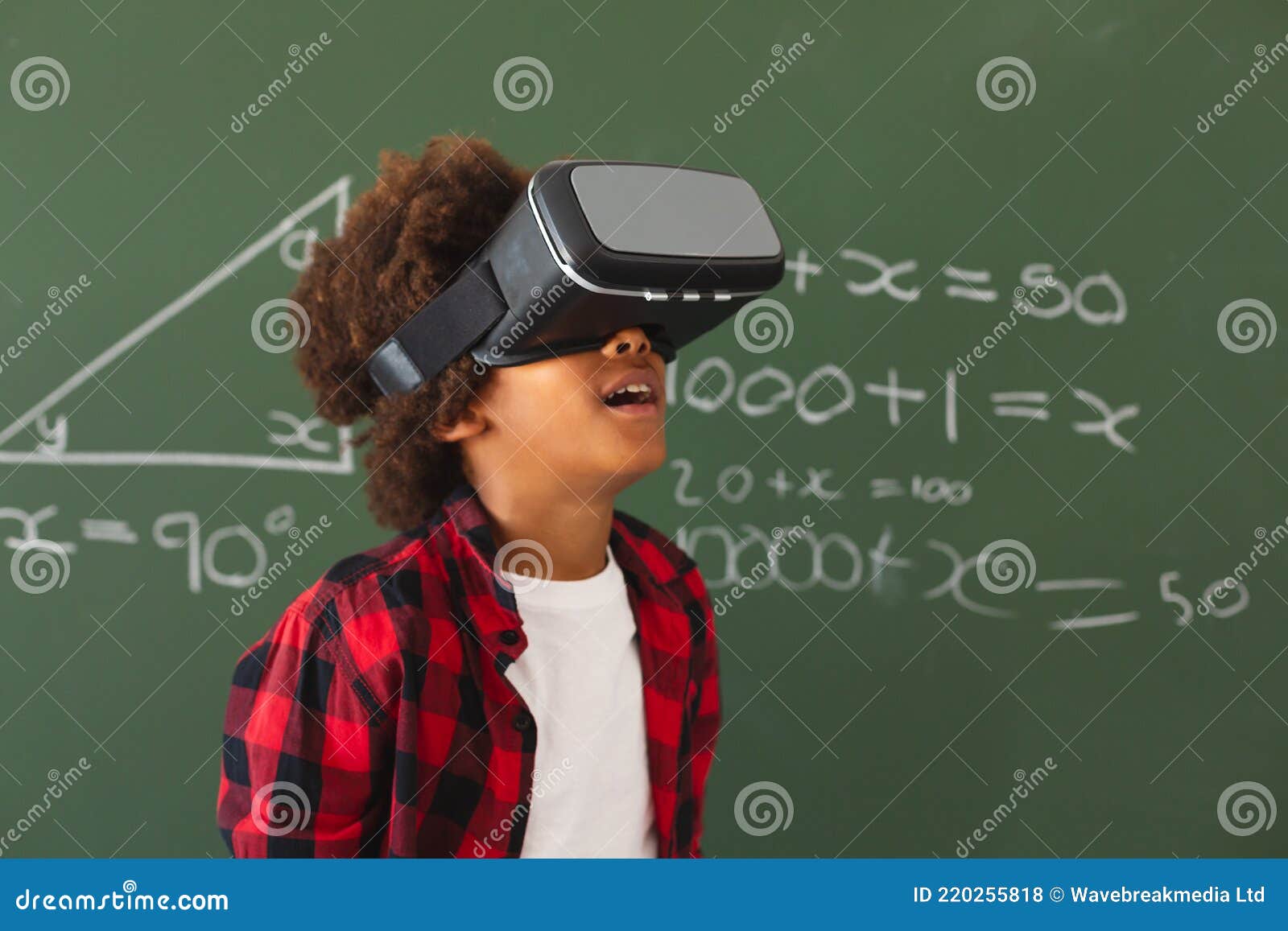 African American Schoolboy in Front of Chalkboard in Classroom Using Vr ...