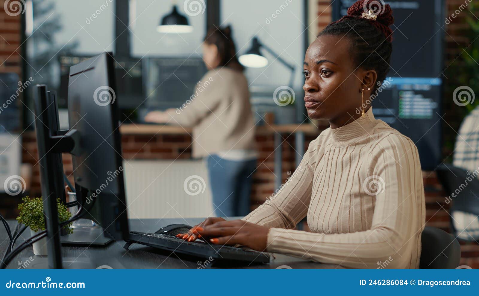 African American Software Engineer Working Focused Looking At Computer Screen While Typing Stock