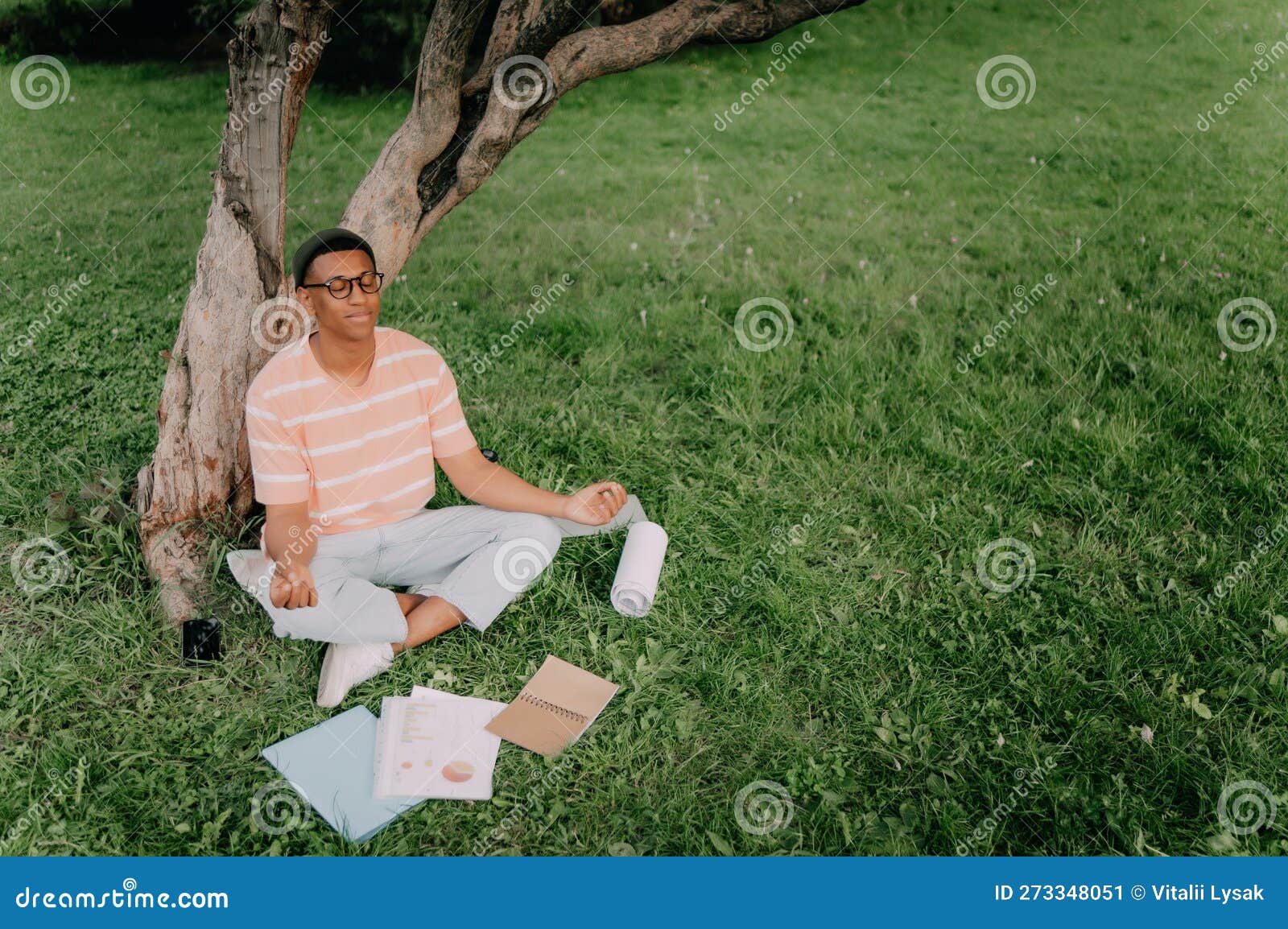 African American Student Meditating Under a Tree in the Park Stock ...