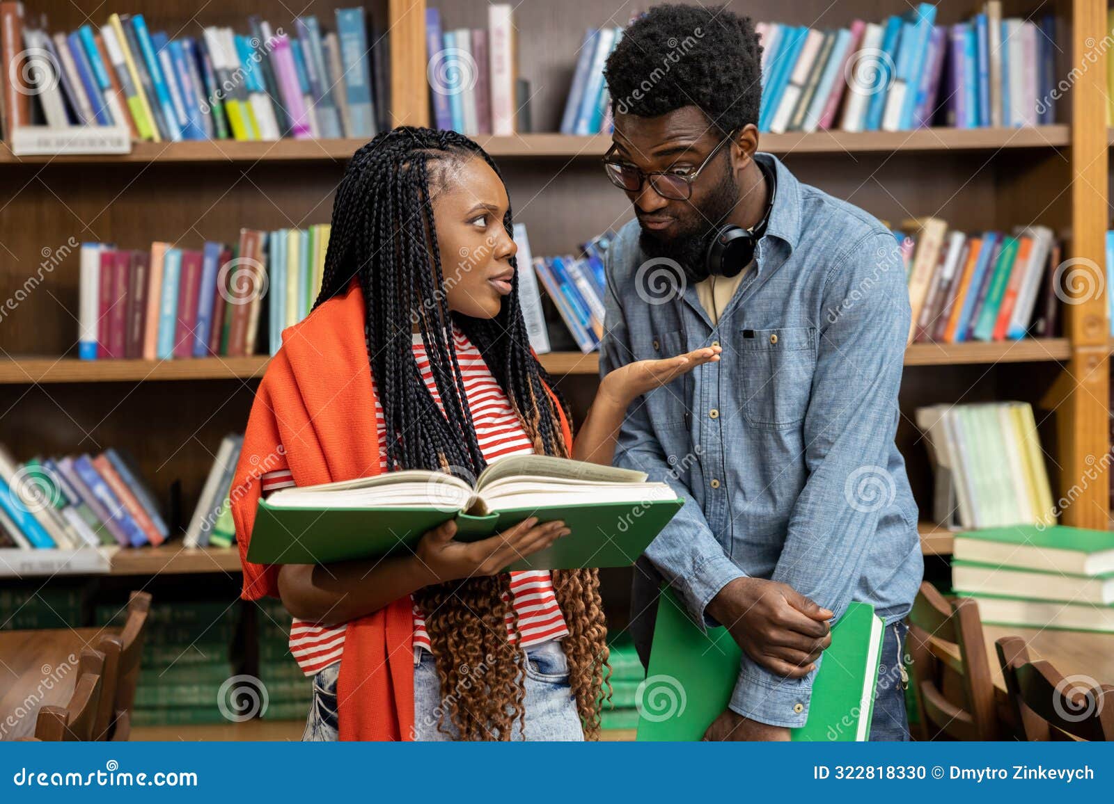 African American Students Discussing Something in the Library Stock ...