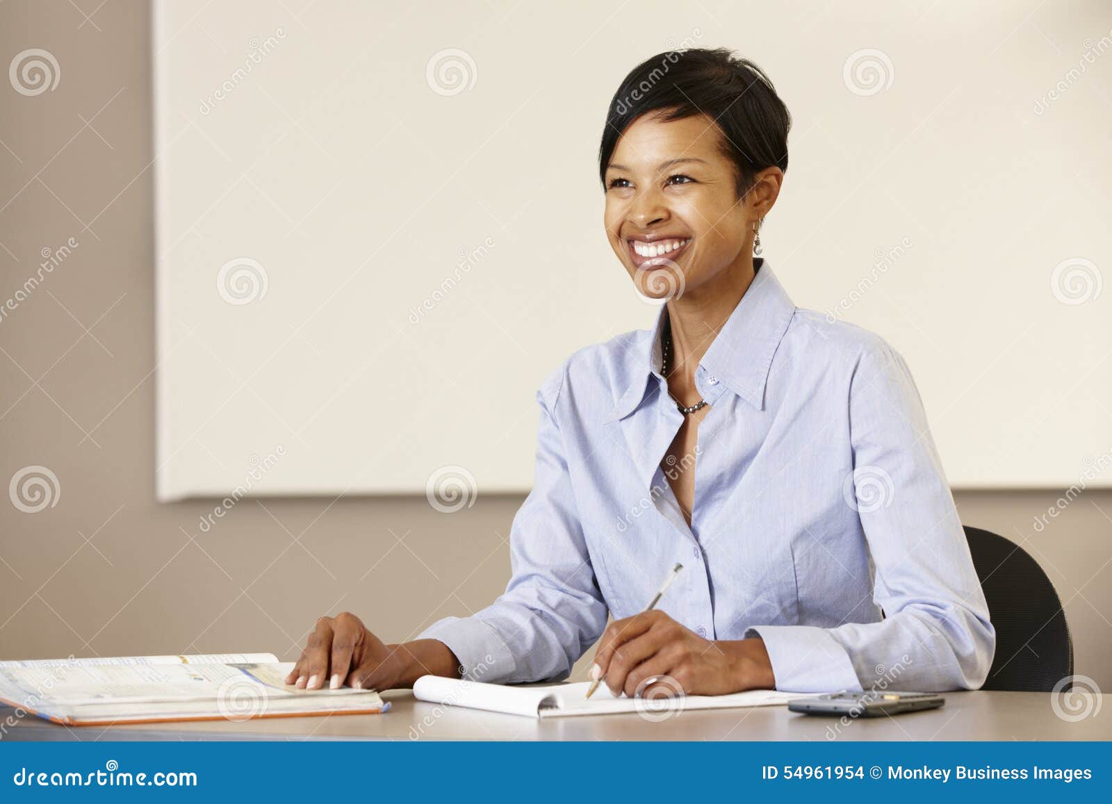 African American Teacher Working at Desk Stock Photo - Image of college ...