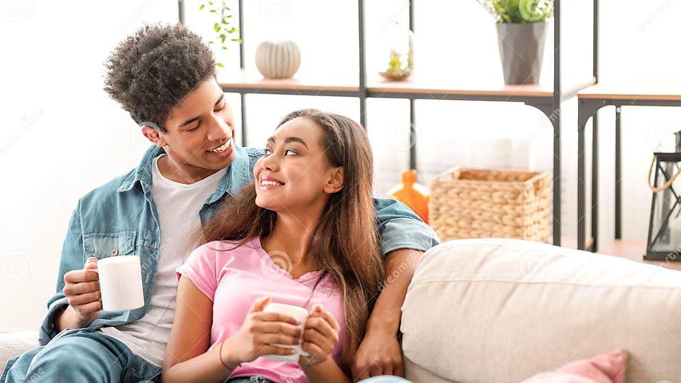 Teen Lovers Relaxing On A Couch And Drinking Coffee Together Stock Image Image Of Floor
