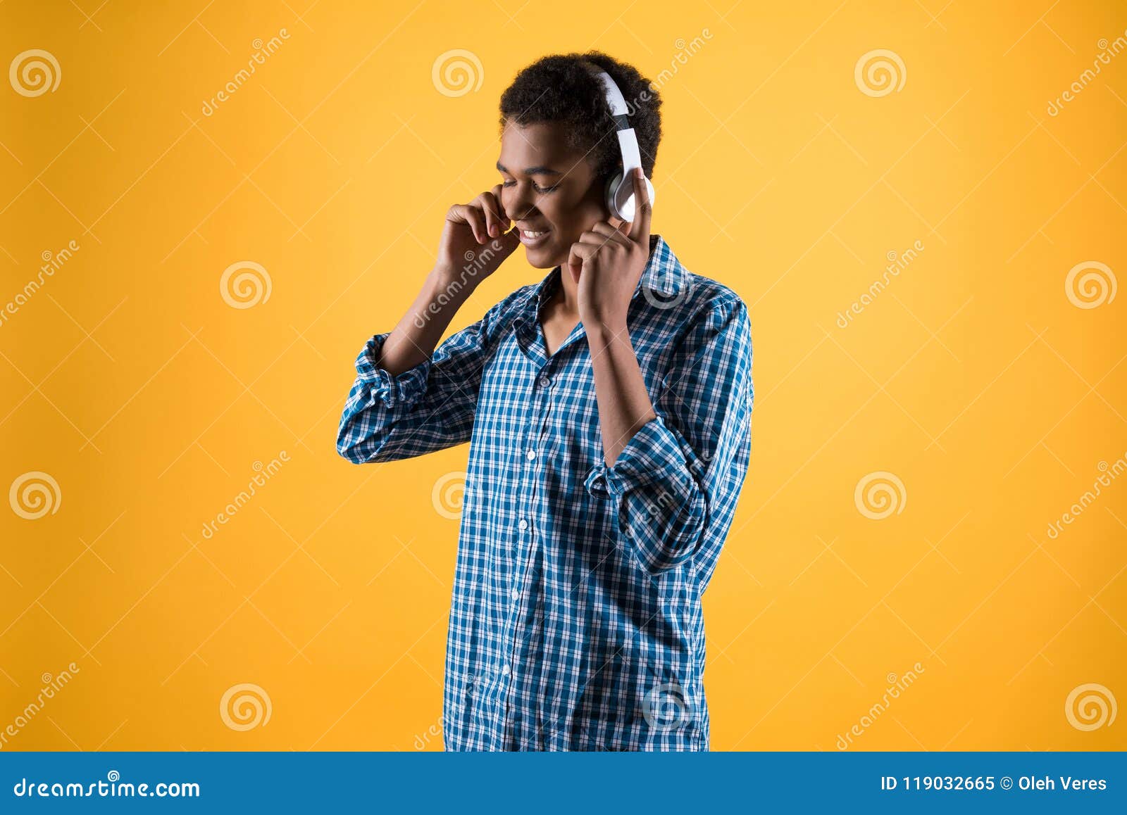 African American Teenager In Headphones Listens To Music Stock Image
