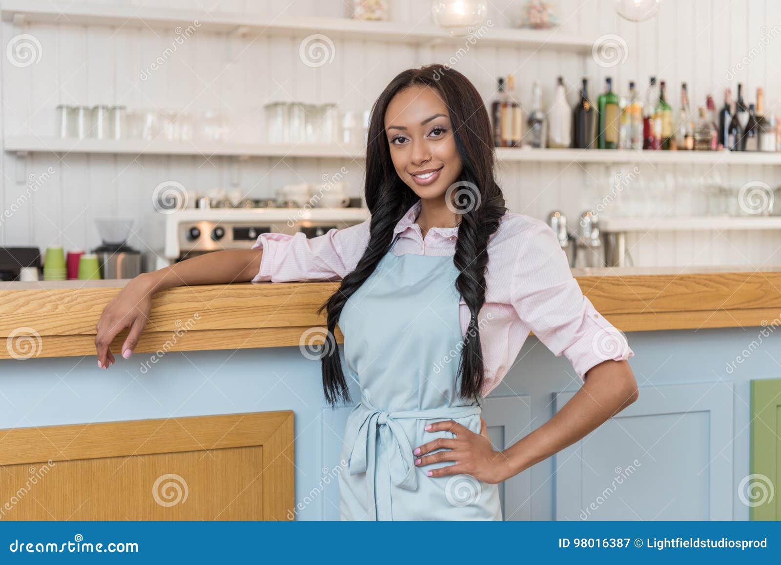 African American Waitress Smiling and Looking at Camera while Standing ...