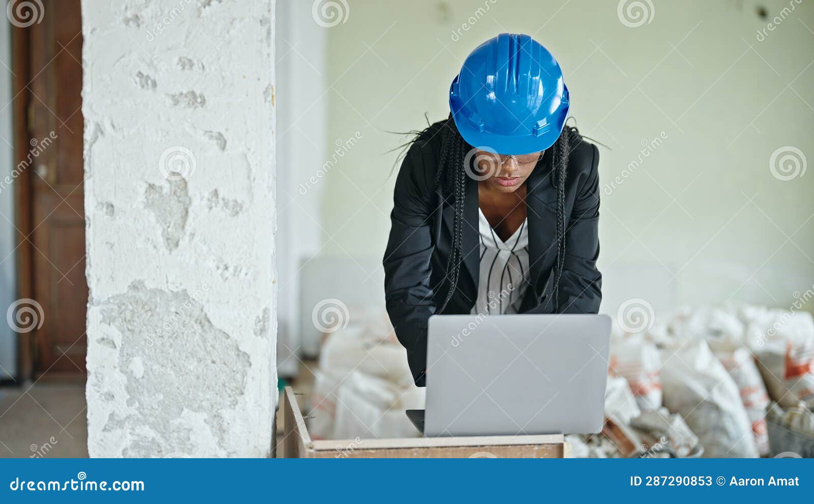 African American Woman Architect Using Laptop at Construction Site ...