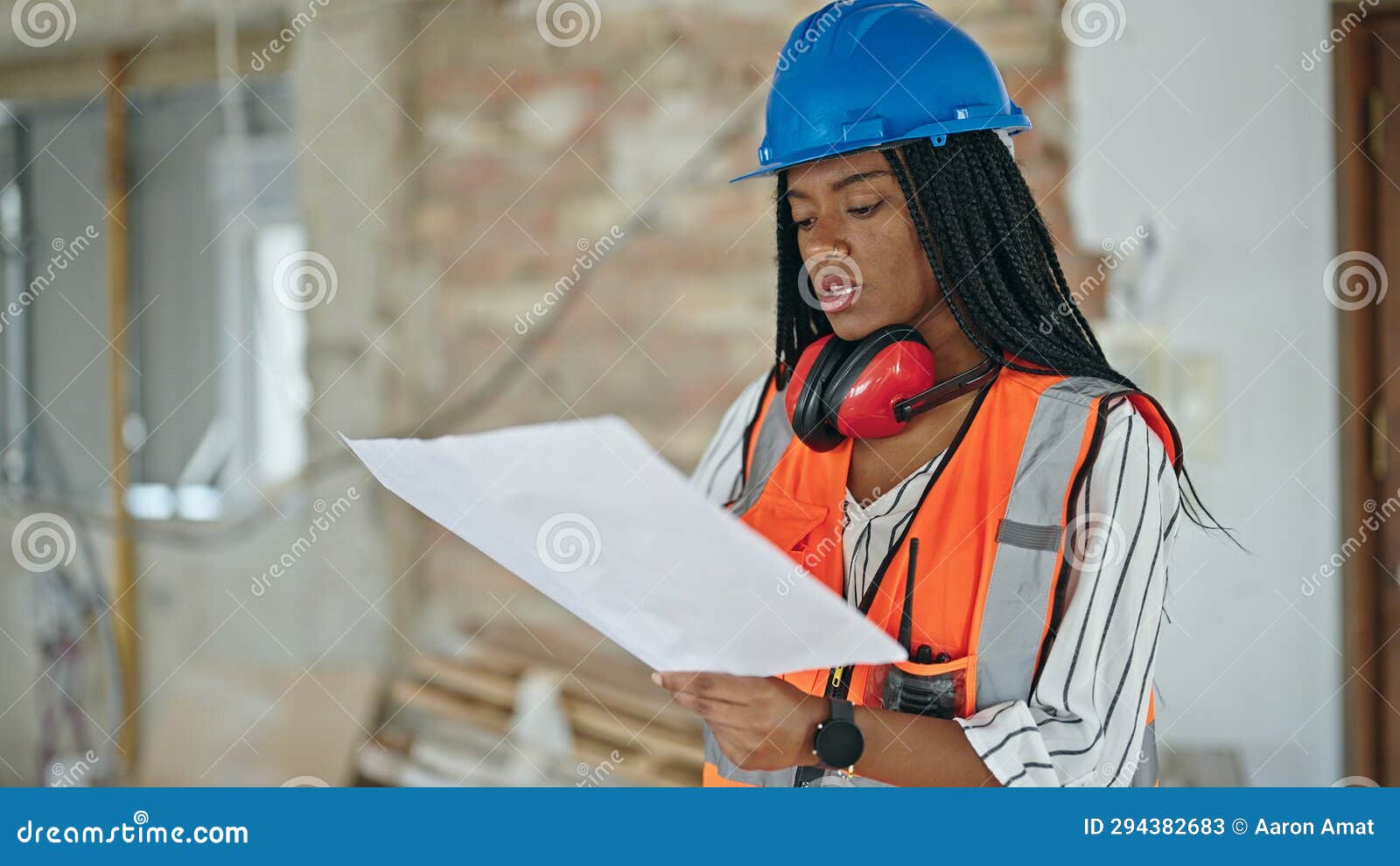 African American Woman Builder Standing with Relaxed Expression Reading ...