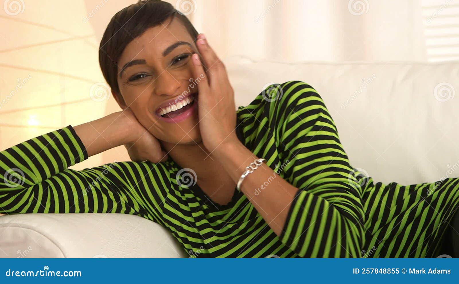 African American Woman Laughing And Smiling While Looking At Camera