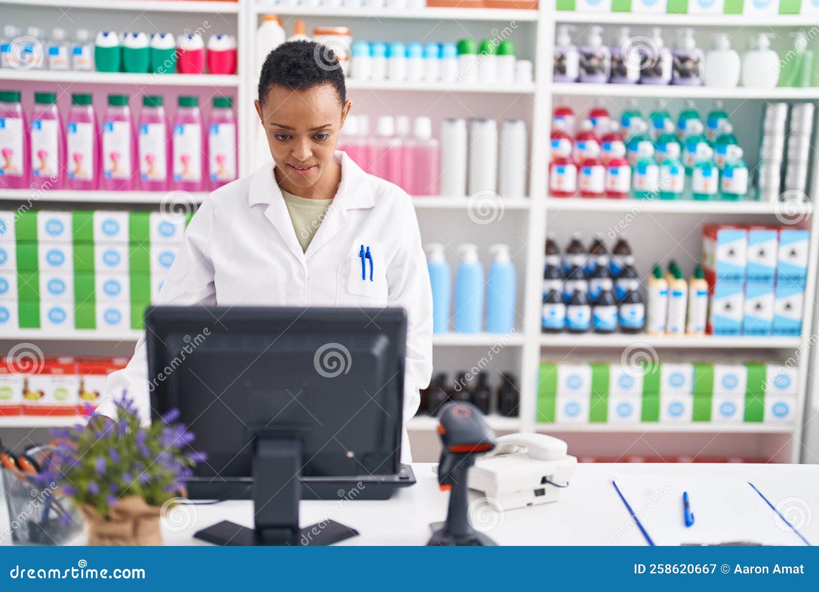 African American Woman Pharmacist Using Computer at Pharmacy Stock ...