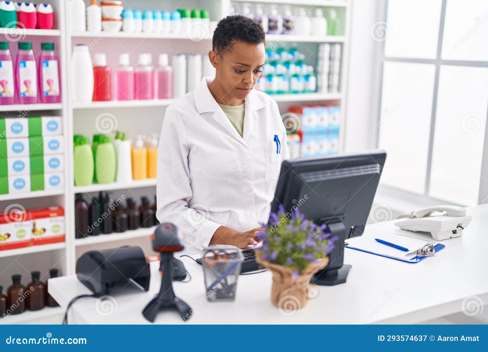 African American Woman Pharmacist Using Computer at Pharmacy Stock ...