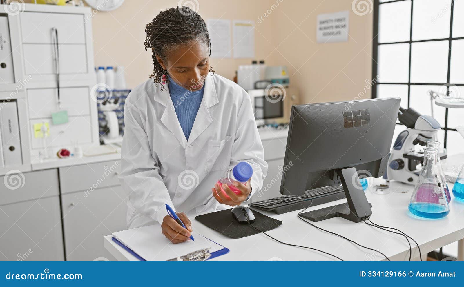African American Woman Scientist Analyzing a Specimen in a Laboratory ...