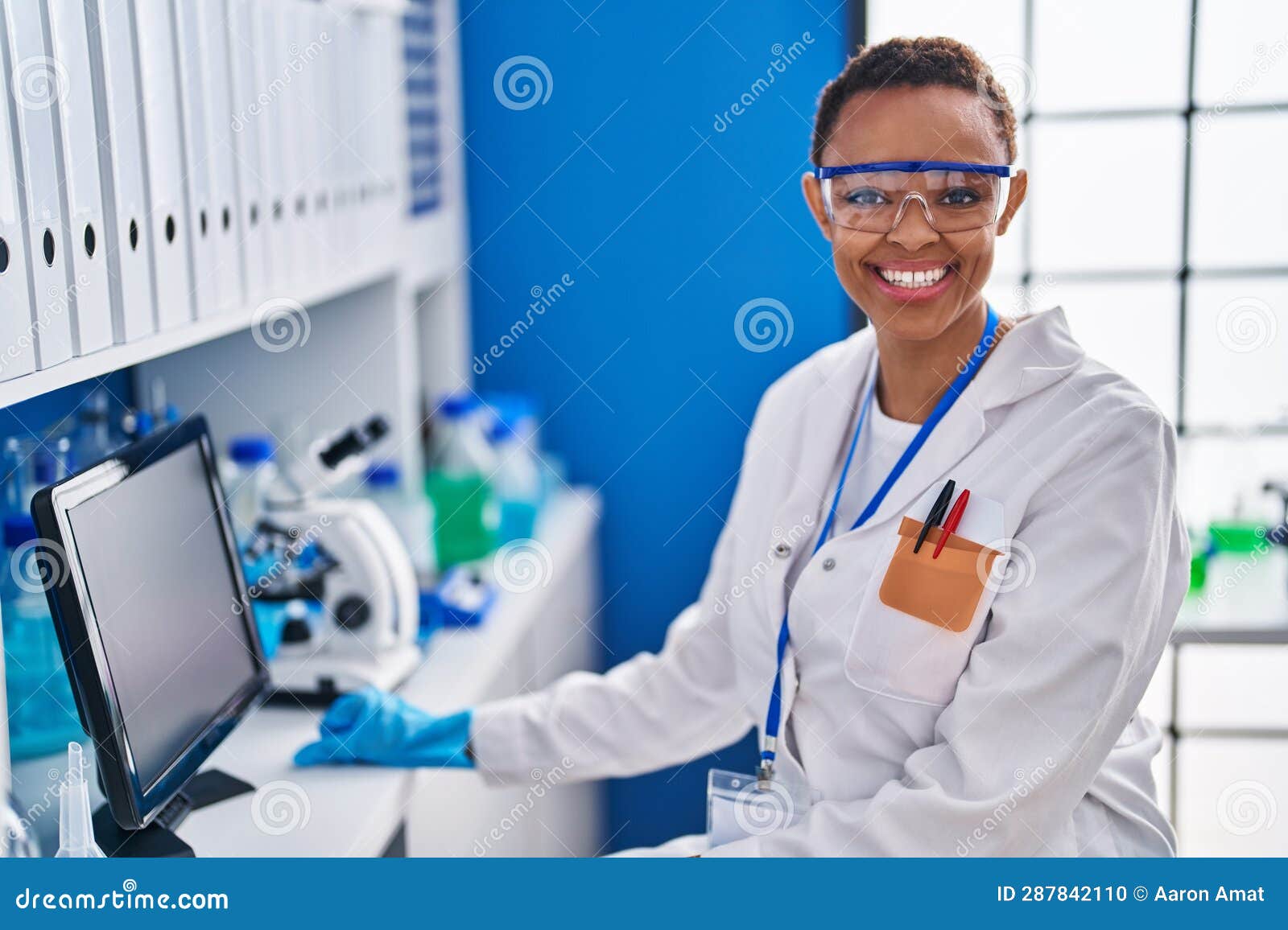 African American Woman Scientist Smiling Confident Using Computer at ...