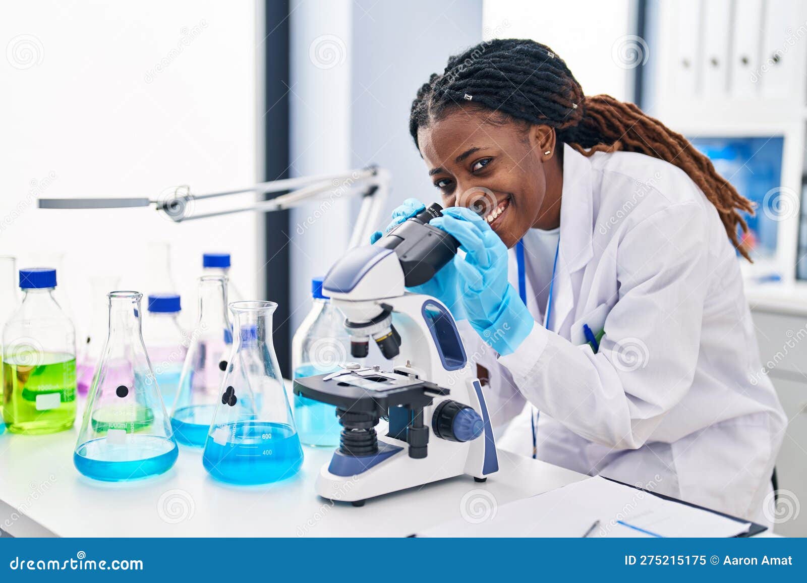 African American Woman Scientist Smiling Confident Using Microscope at ...