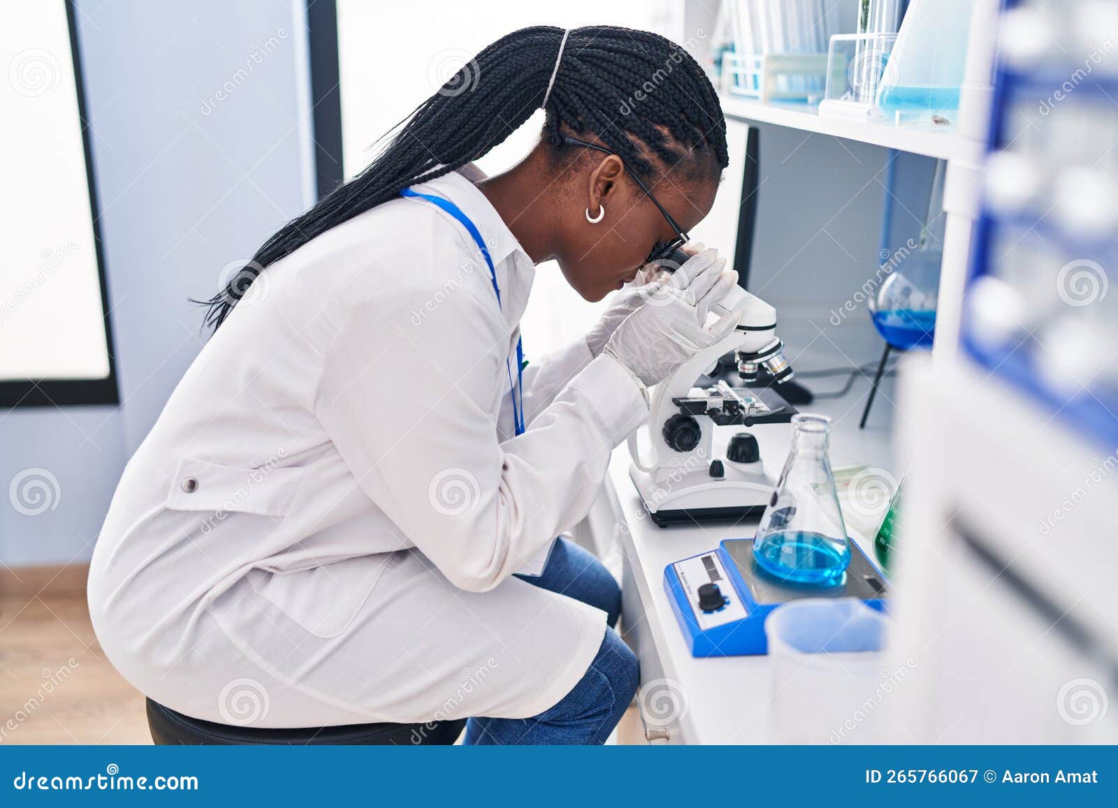 African American Woman Scientist Using Microscope at Laboratory Stock ...