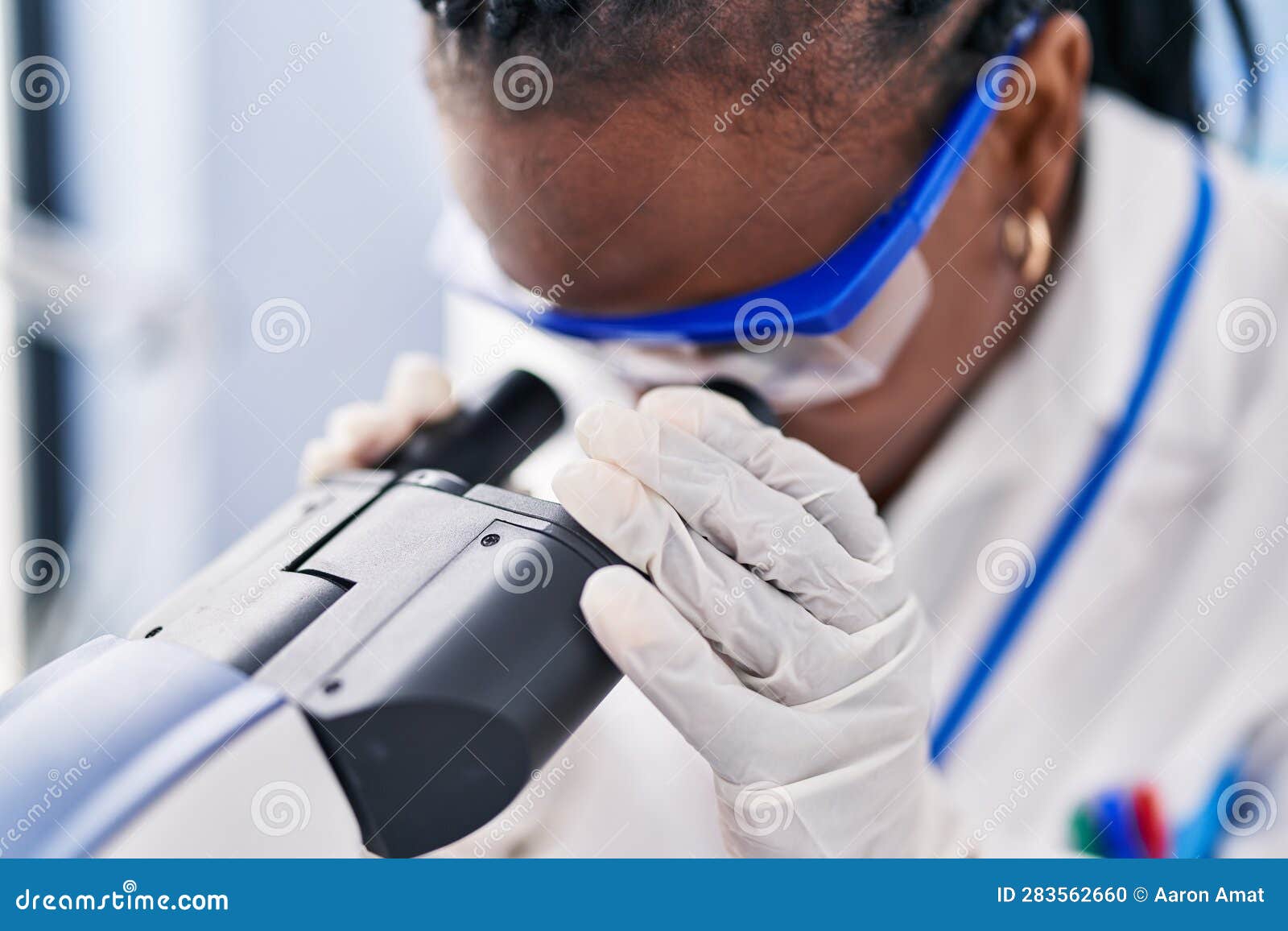African American Woman Scientist Using Microscope at Laboratory Stock ...