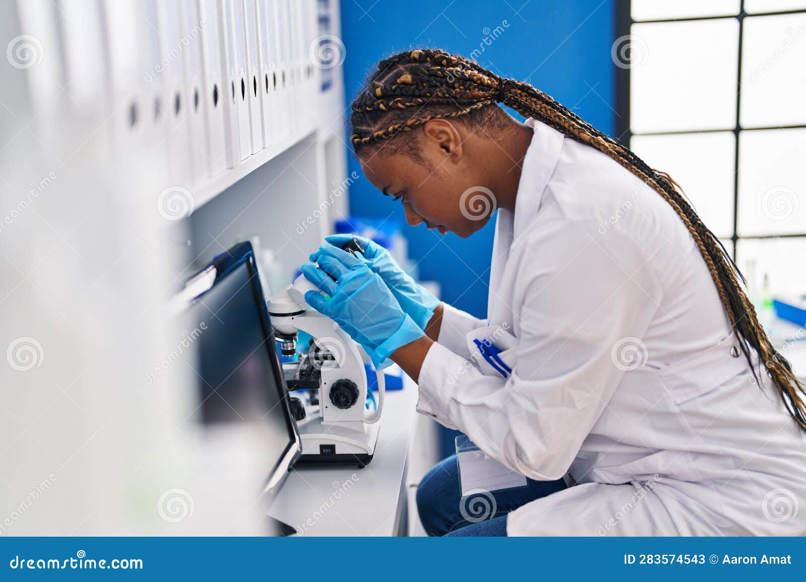 African American Woman Scientist Using Microscope at Laboratory Stock ...