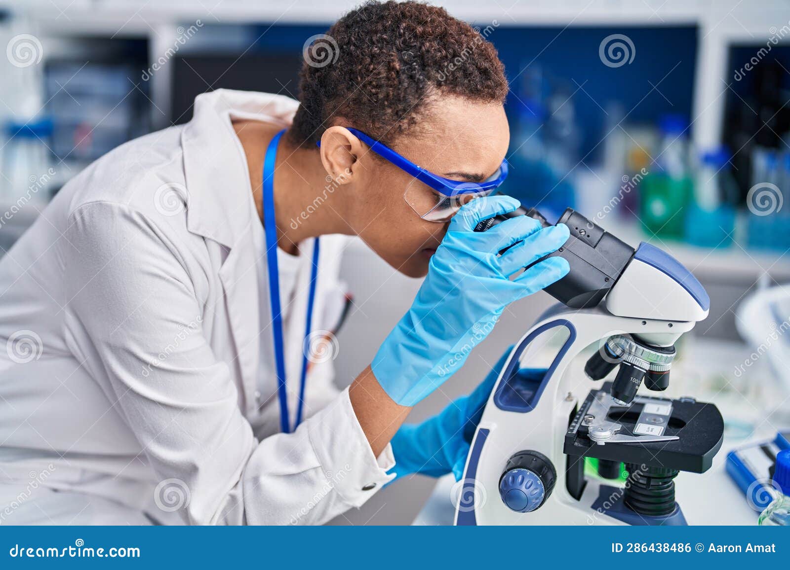 African American Woman Scientist Using Microscope at Laboratory Stock ...