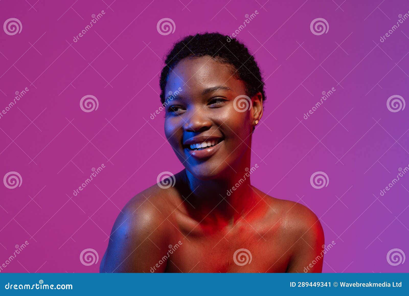 African American Woman With Short Hair Looking Away Smiling In Blue And