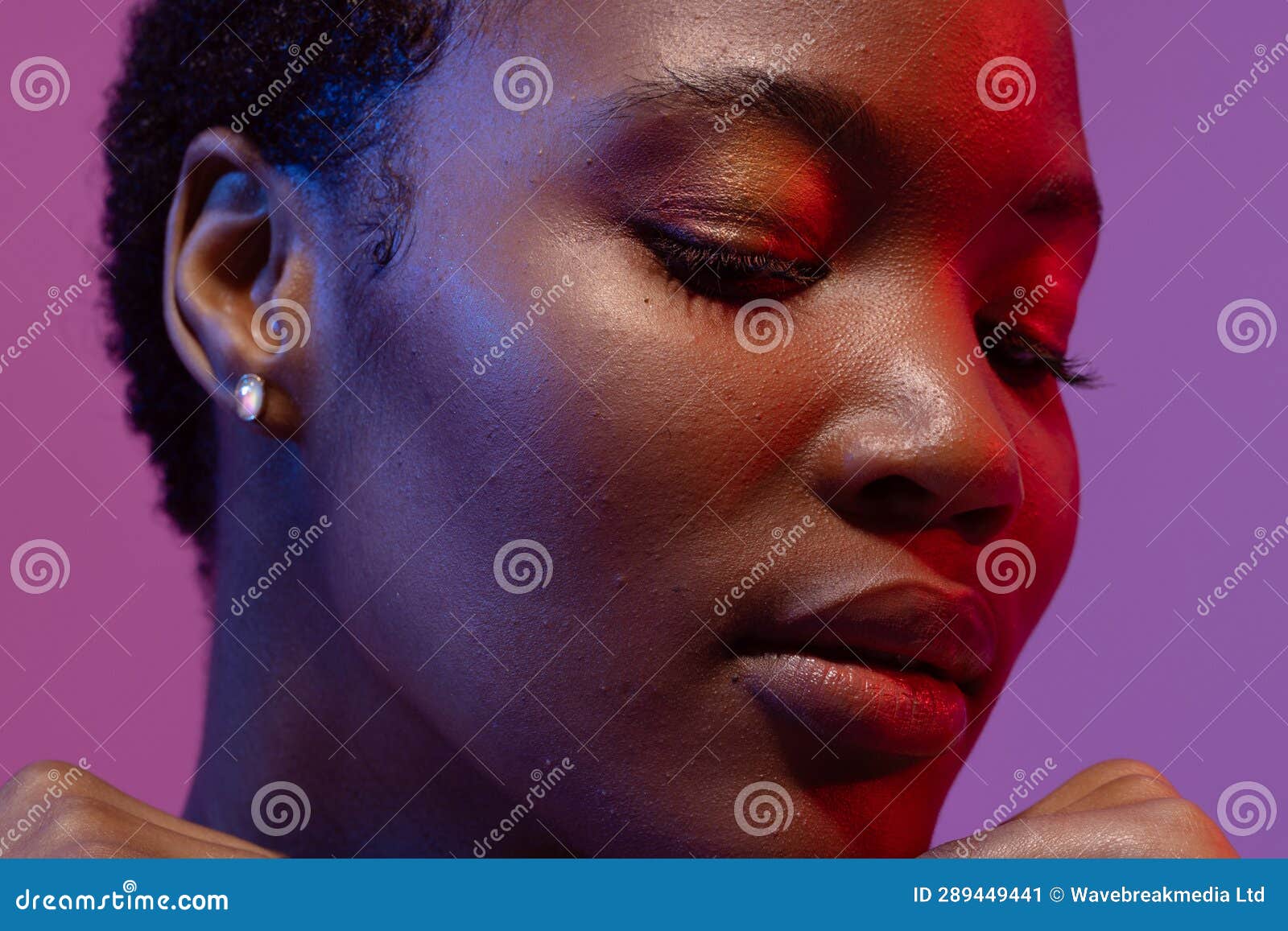 African American Woman With Short Hair Looking Down In Red And Blue