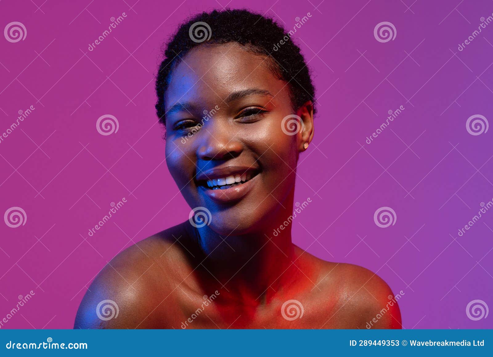 African American Woman With Short Hair Smiling In Blue And Red Light On