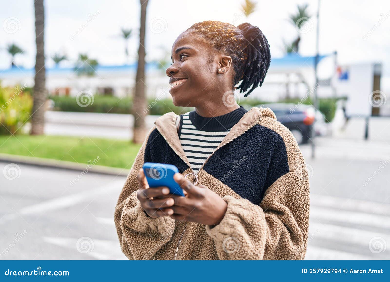 African American Woman Smiling Confident Using Smartphone At Street
