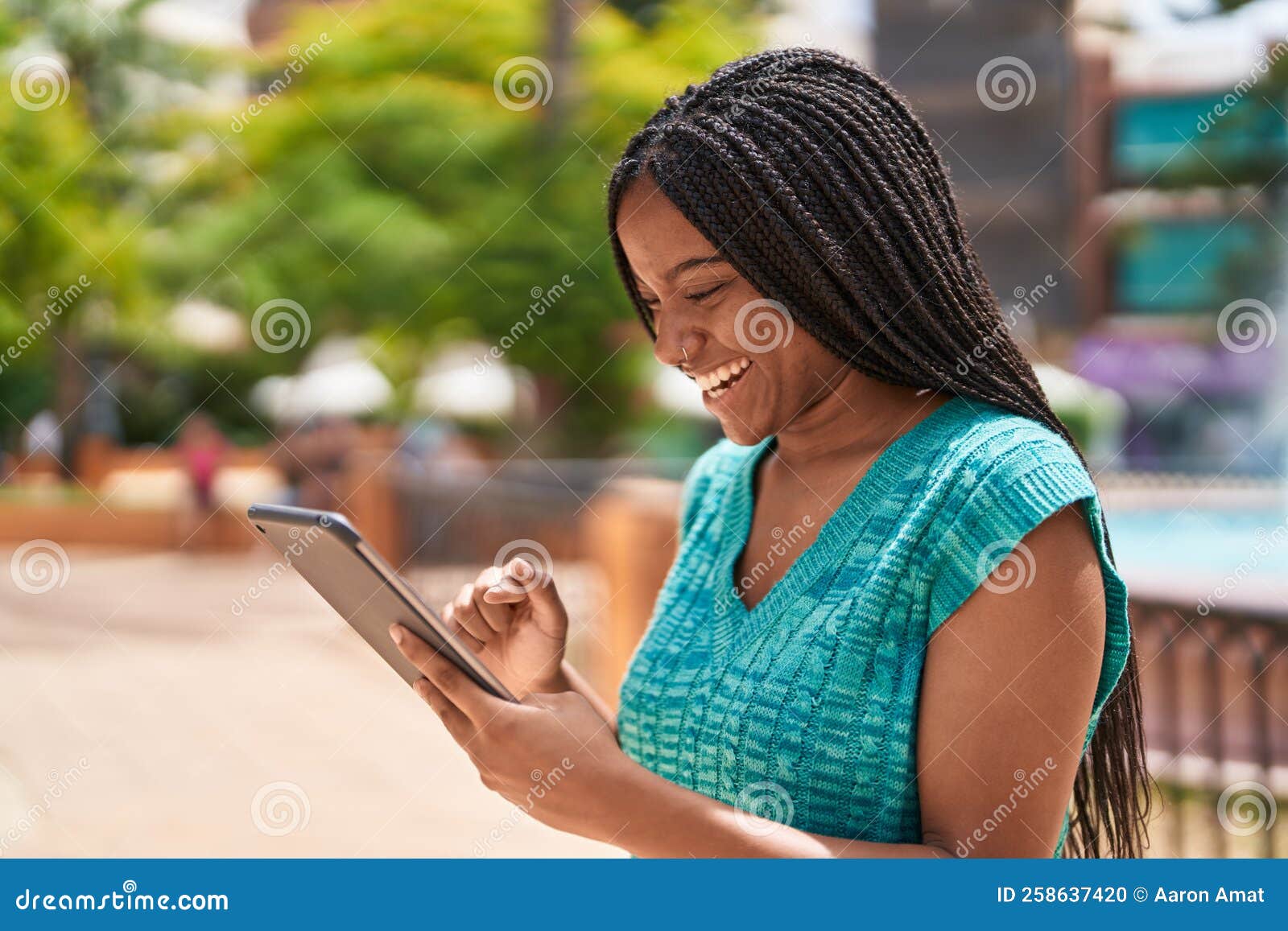 African American Woman Smiling Confident Using Touchpad at Park Stock ...