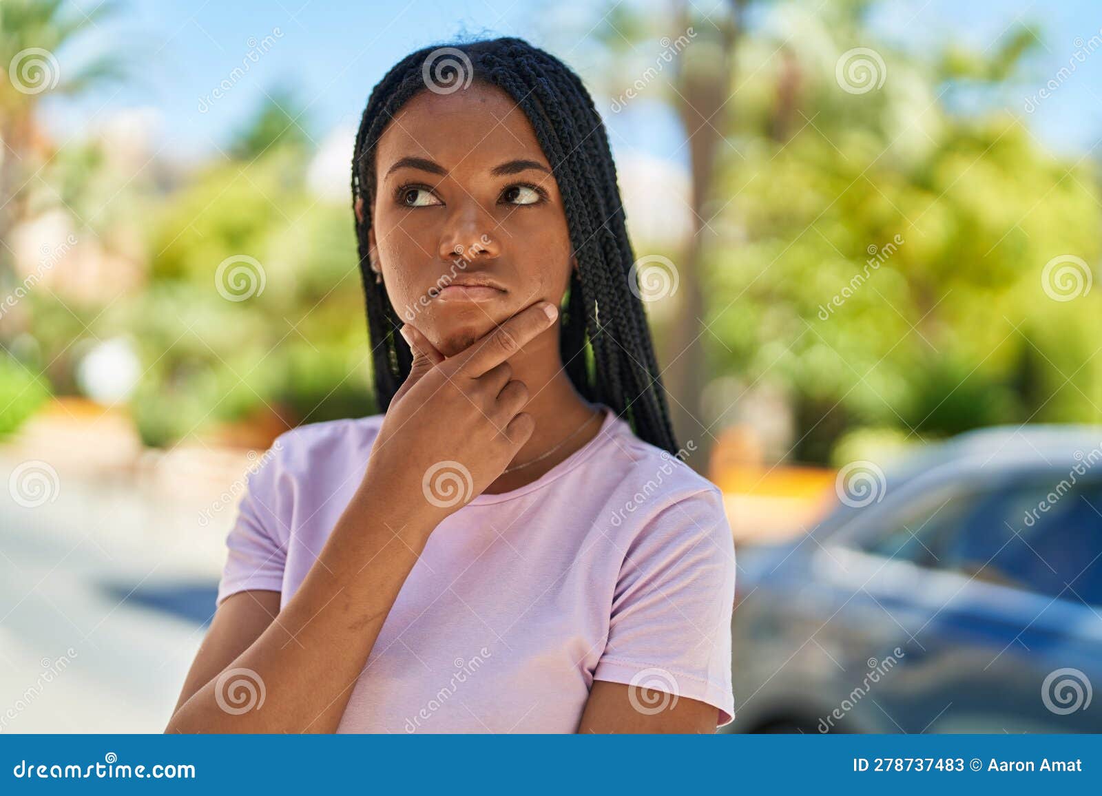 African American Woman Standing with Doubt Expression at Park Stock ...