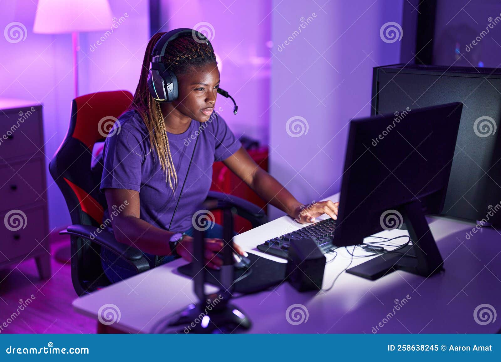 African American Woman Streamer Playing Video Game Using Computer at ...