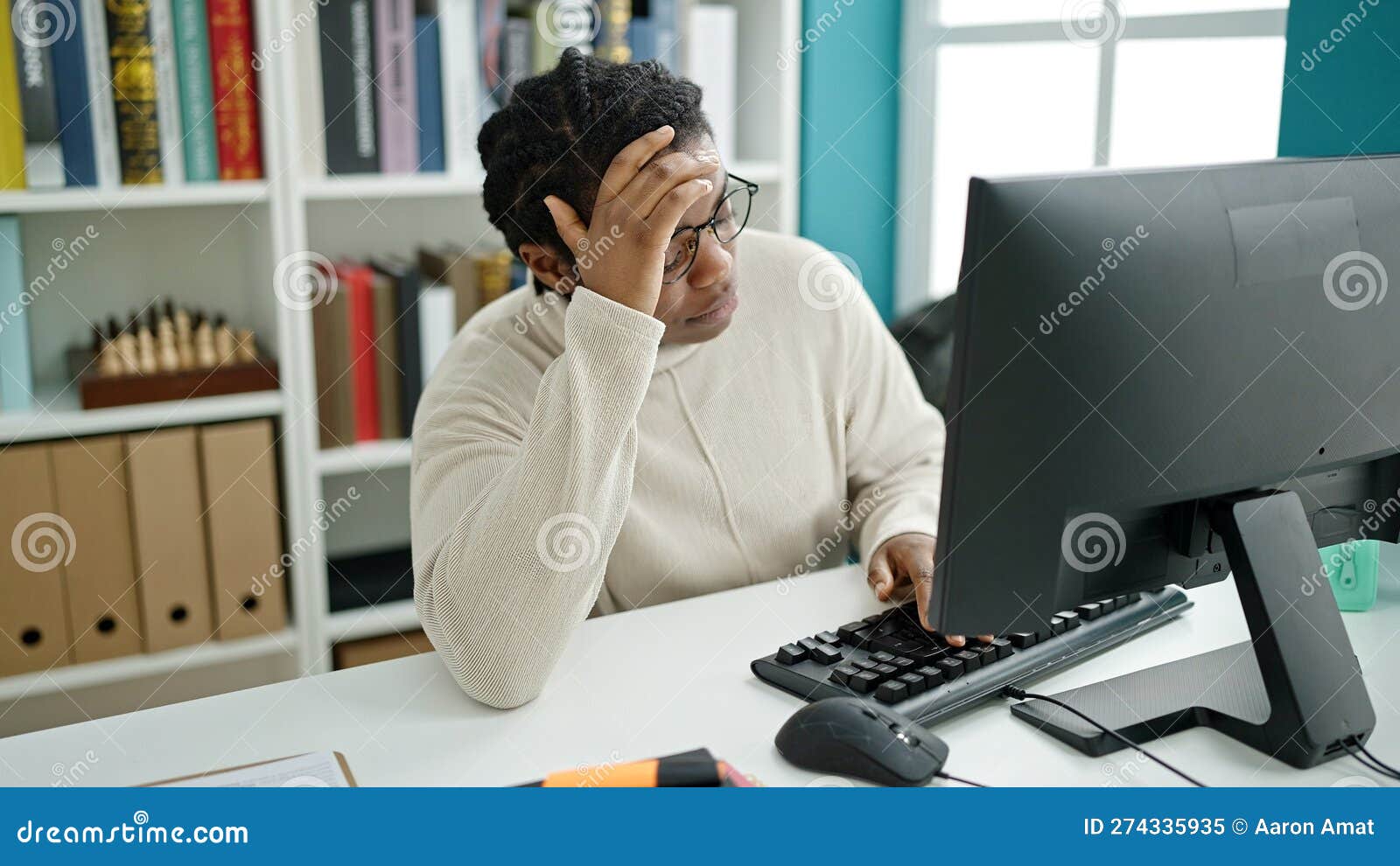 African American Woman Student Using Computer Stressed at Library ...