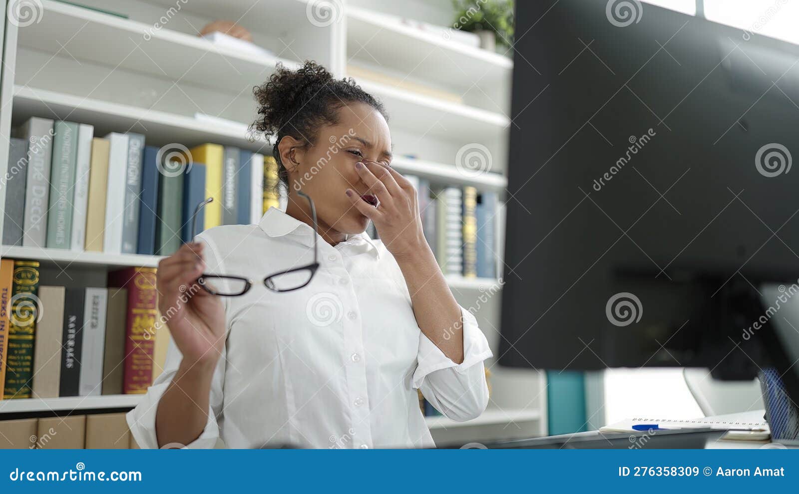 African American Woman Student Using Computer Stressed at Library ...