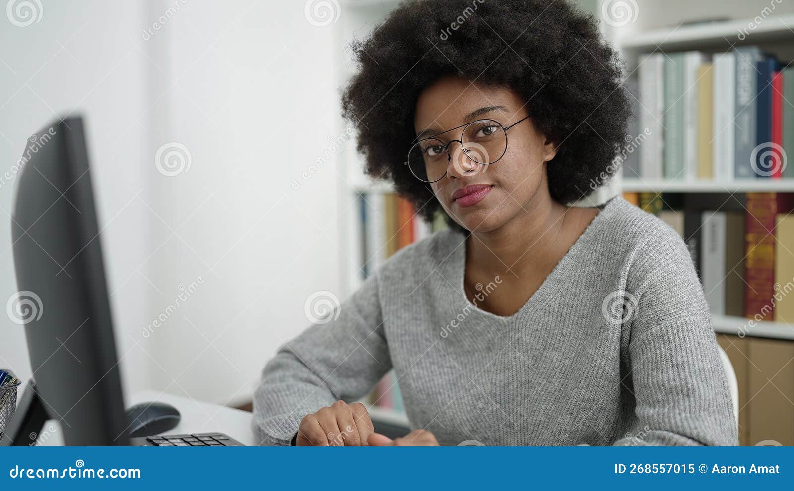 African American Woman Student Using Computer Studying at Library ...