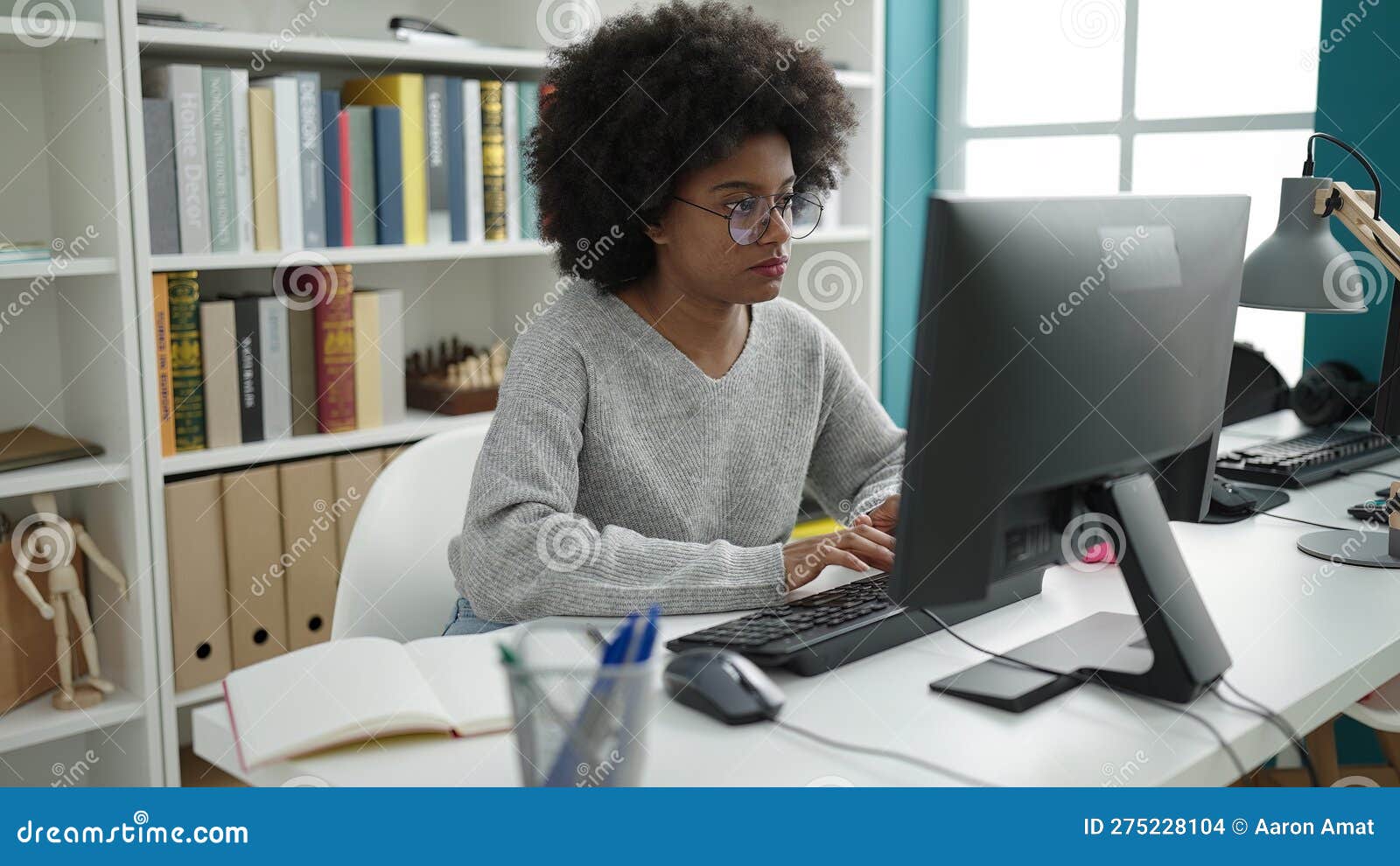 African American Woman Student Using Computer Studying at Library ...