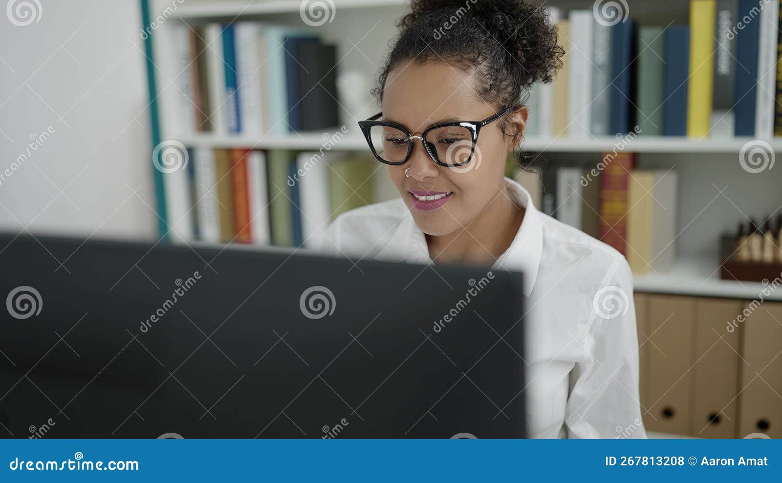 African American Woman Student Using Computer Studying at Library ...