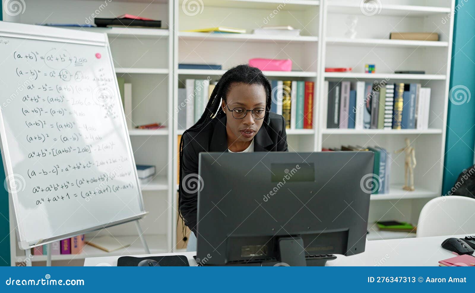 African American Woman Teacher Teaching Maths Lesson Using Computer at ...