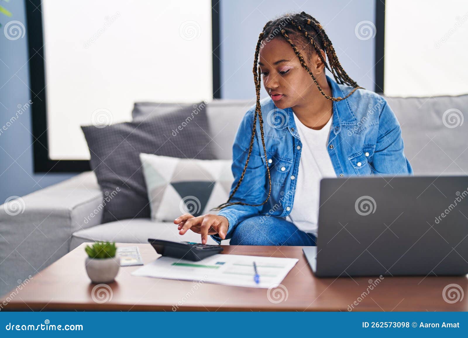 African American Woman Using Laptop Accounting at Home Stock Photo ...