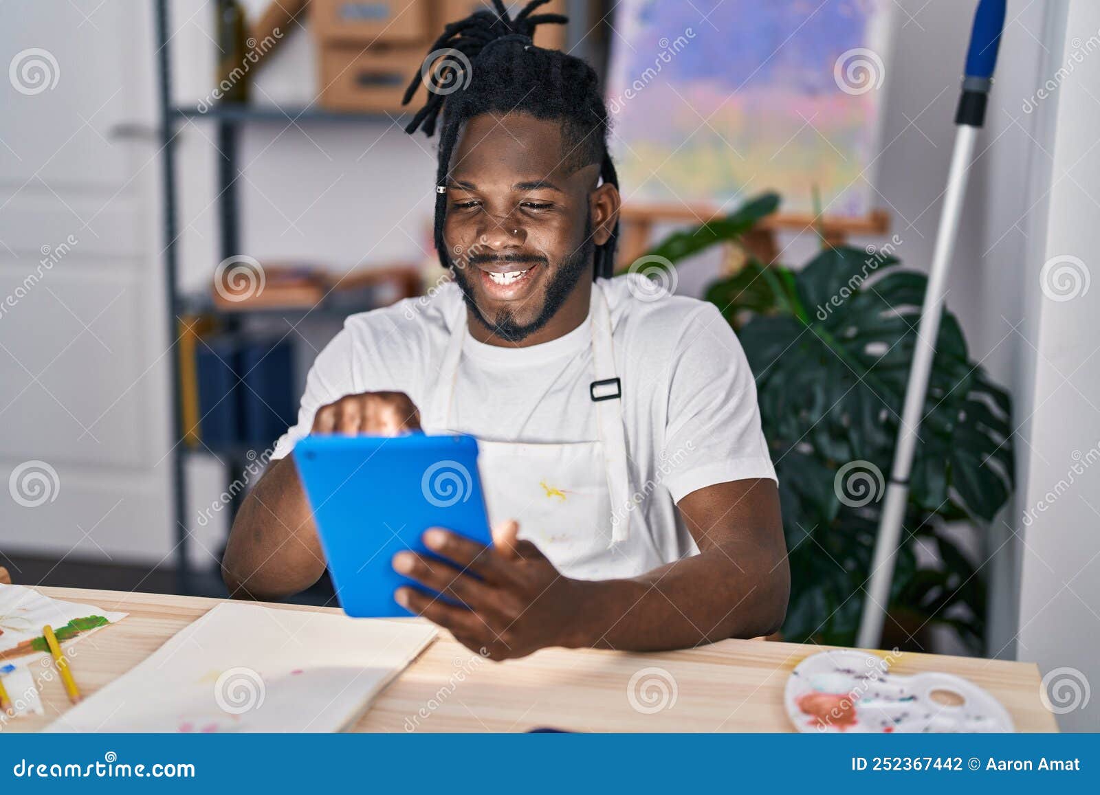 African American Woman Using Touchpad Drawing on Notebook at Art Studio ...