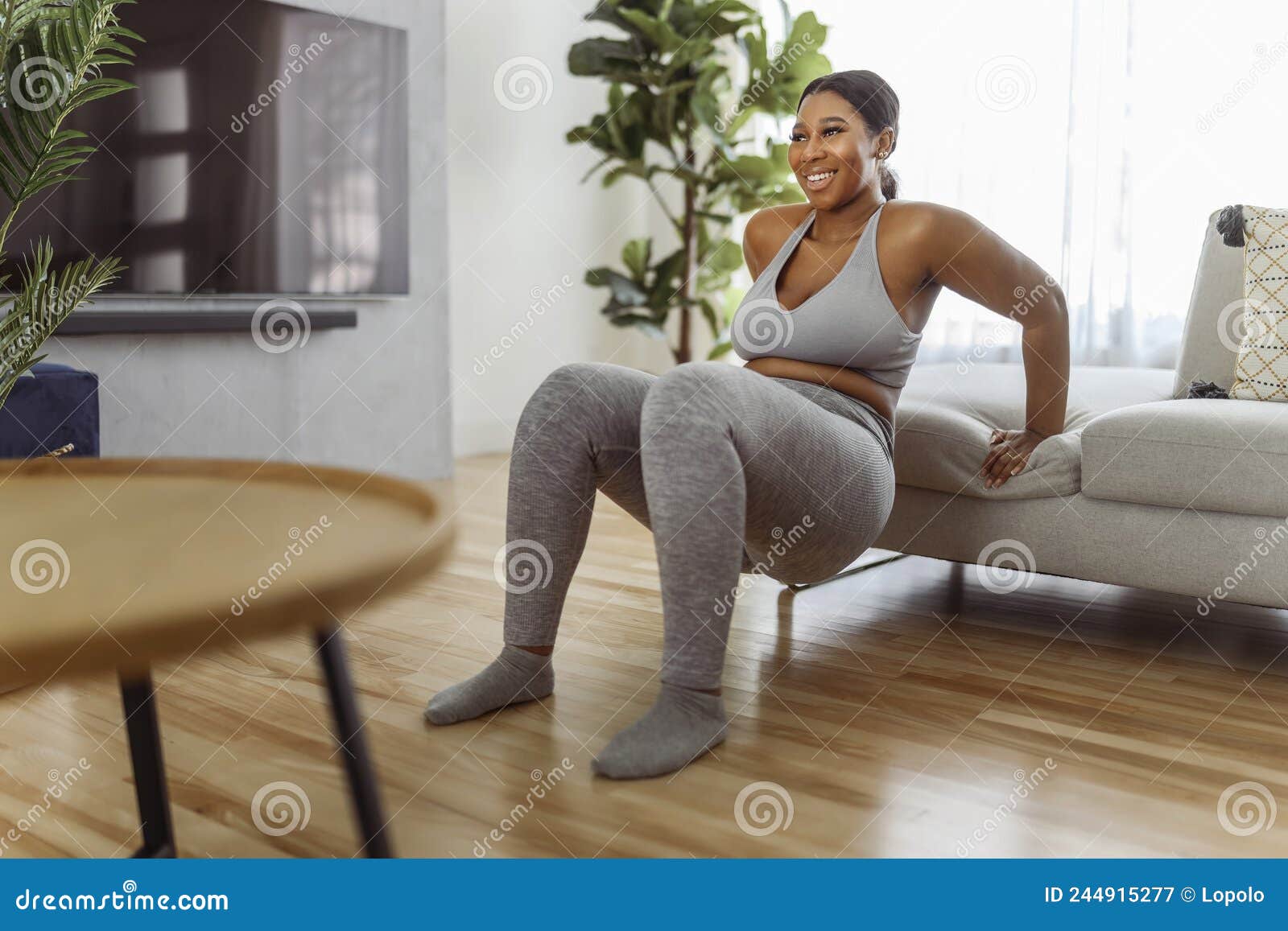 African American Woman Working Out In Home Livingroom Gym Stock Image