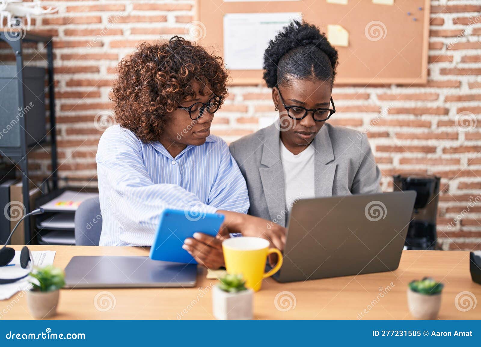 African American Women Business Workers Using Touchpad Working at ...